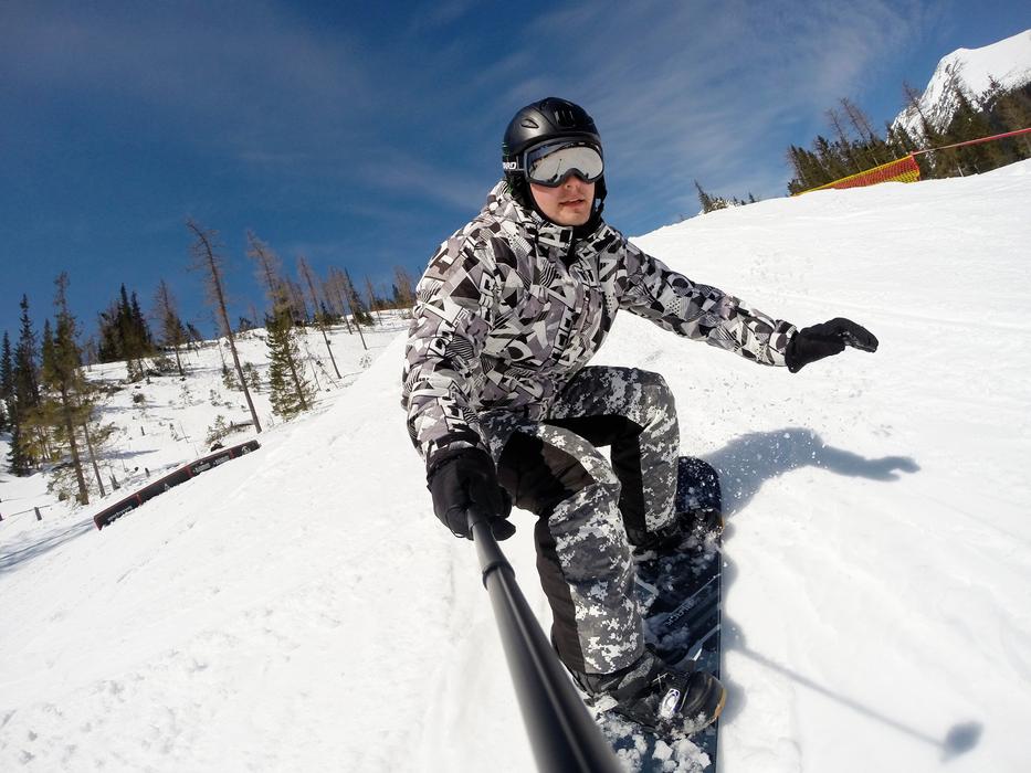 Snowboarding man with camera free image download