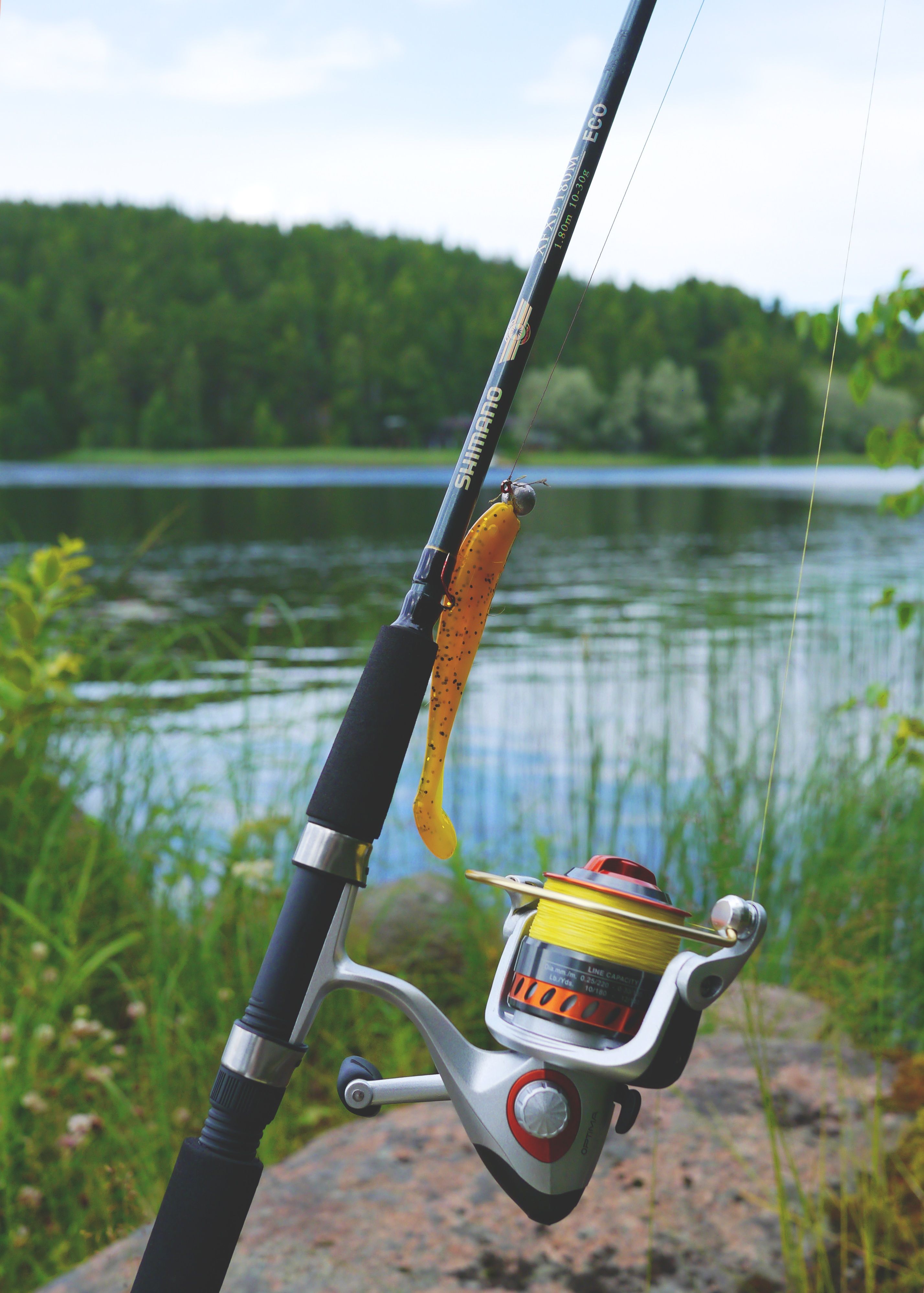 Fishing rod with reel near water close-up free image download