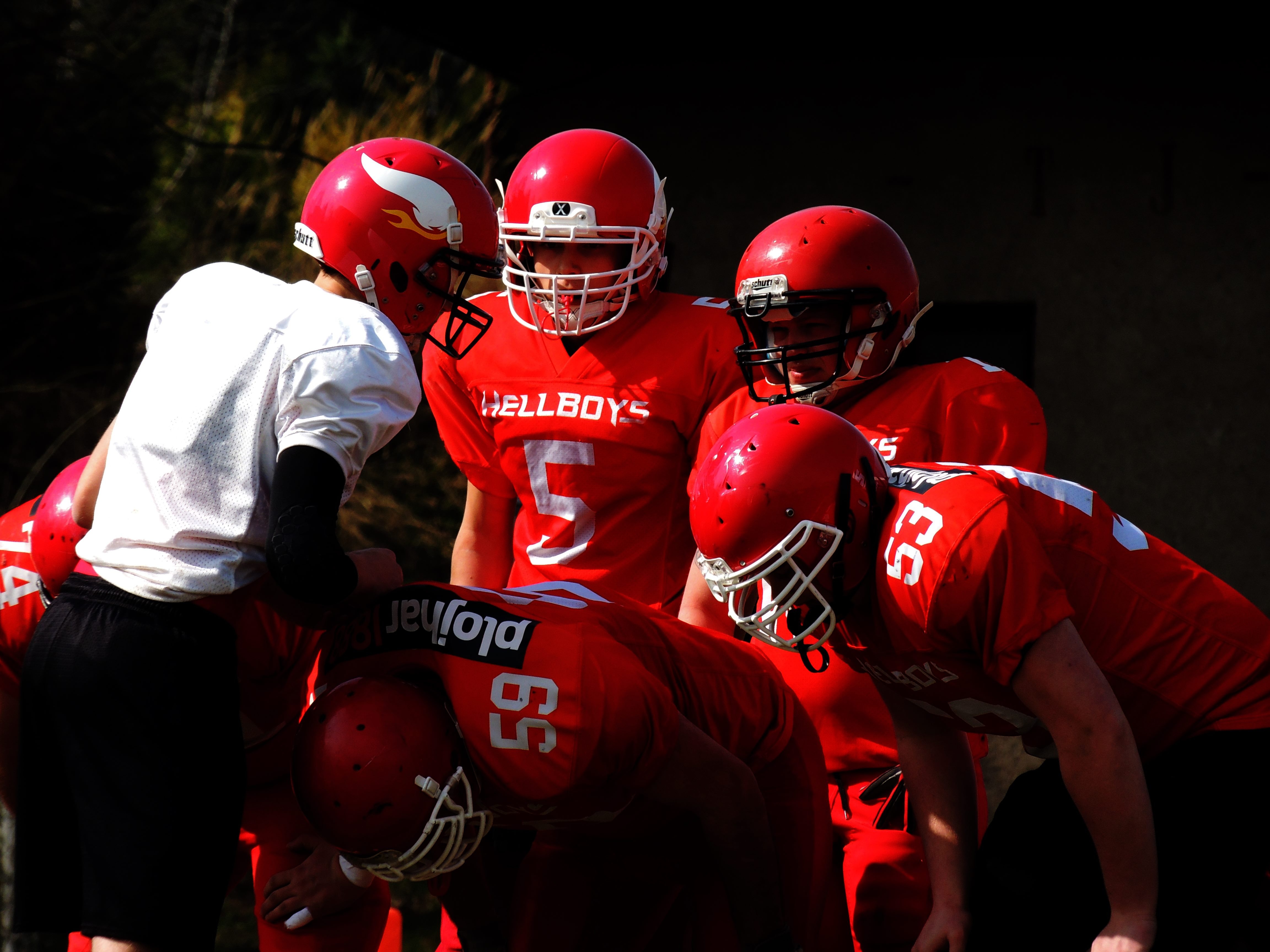 Meeting of american football players in red uniform free image download