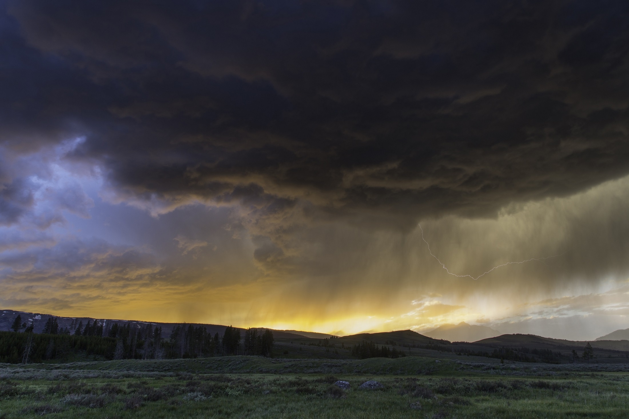 Thunderstorm over meadow and hills at Sunset free image download