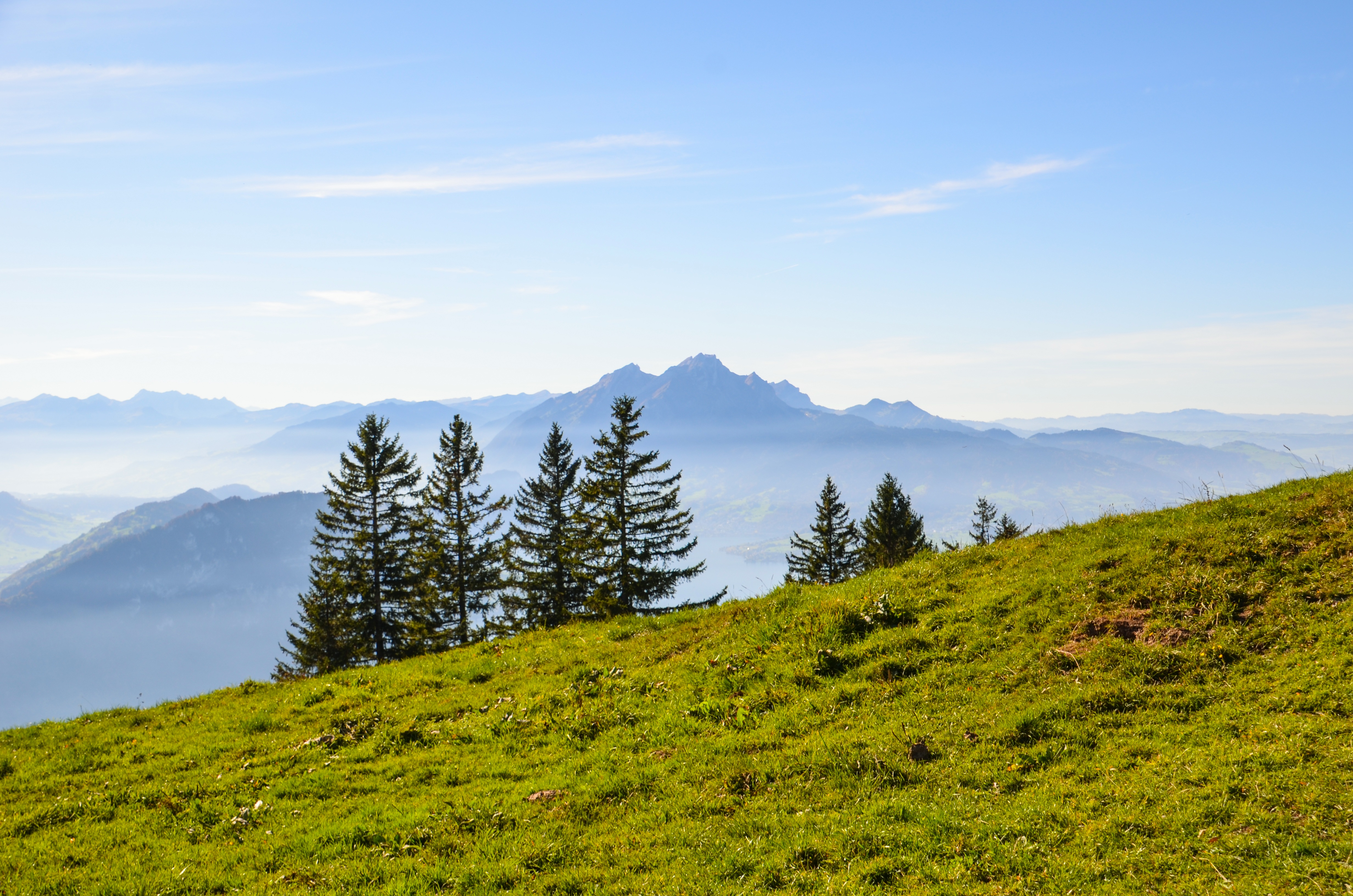 Green slope and mountains in the distance free image download