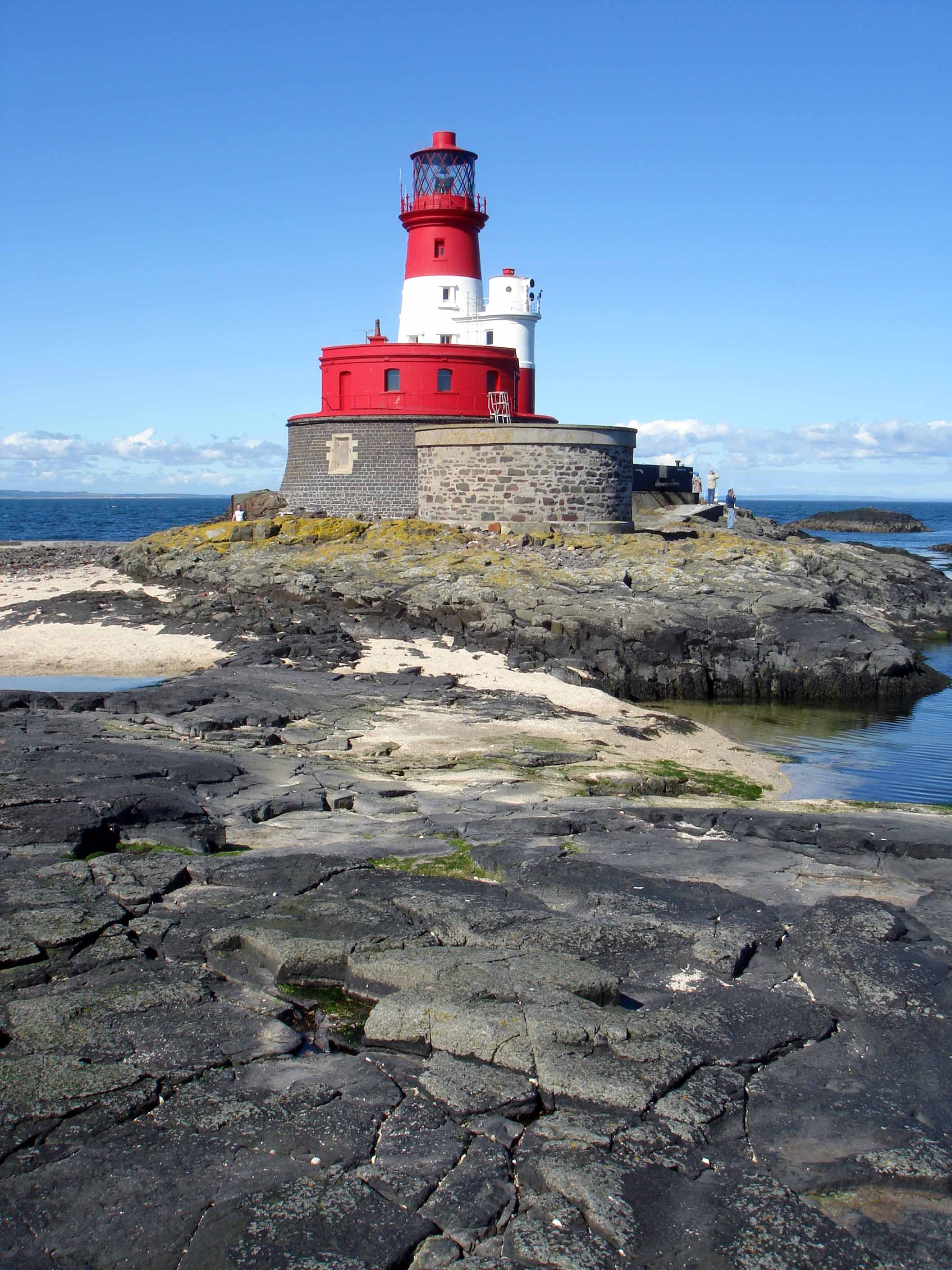 Lighthouse on rocky Coast Sky free image download