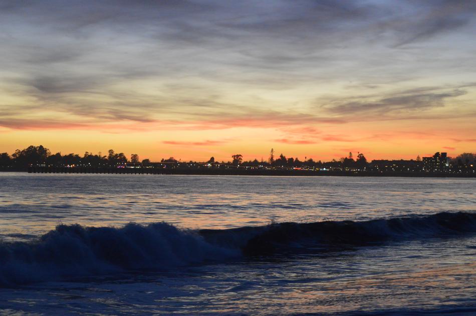 Sunset against a wave of the sea free image download