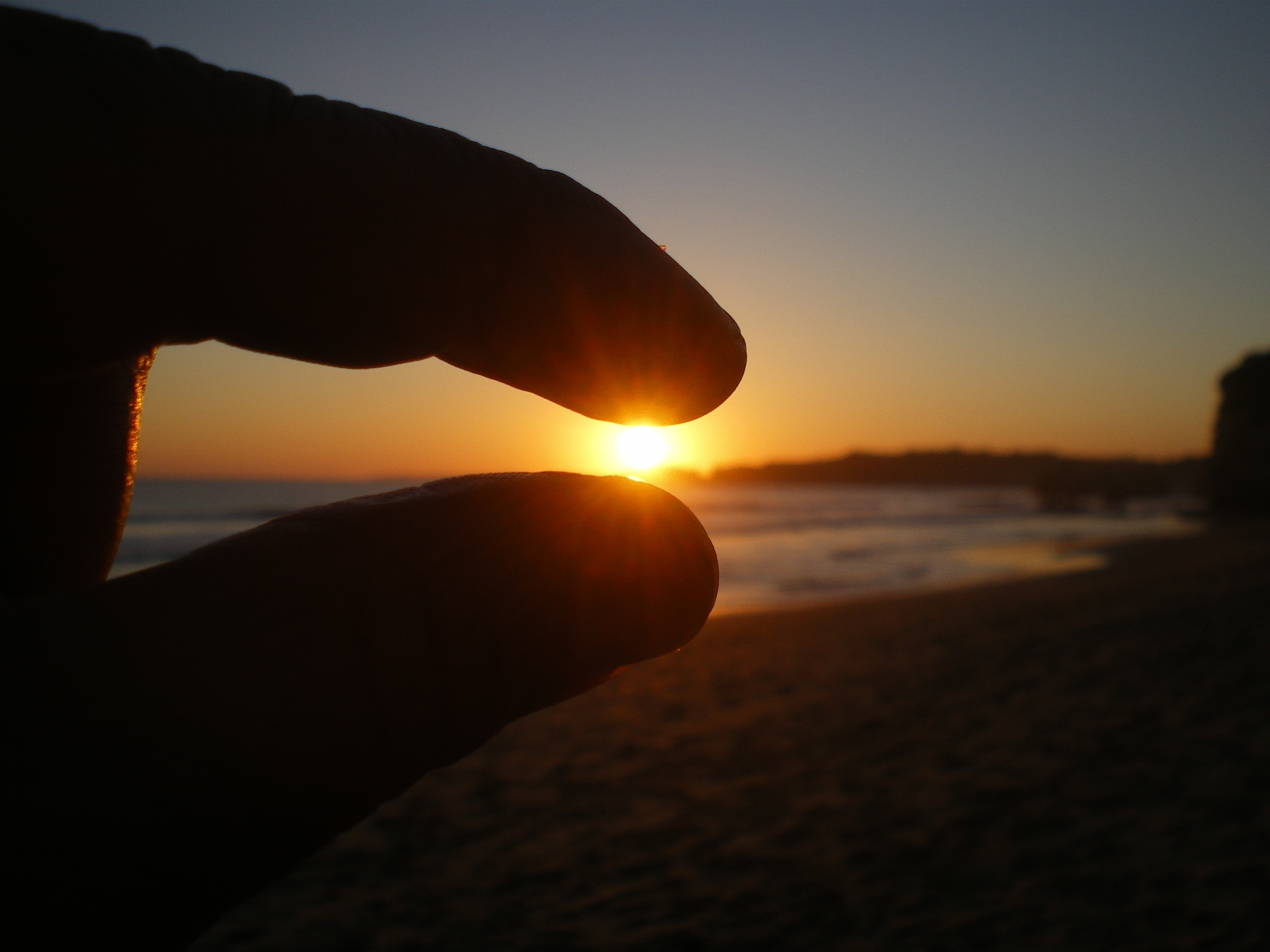 Fingers holding Sun photo free image download
