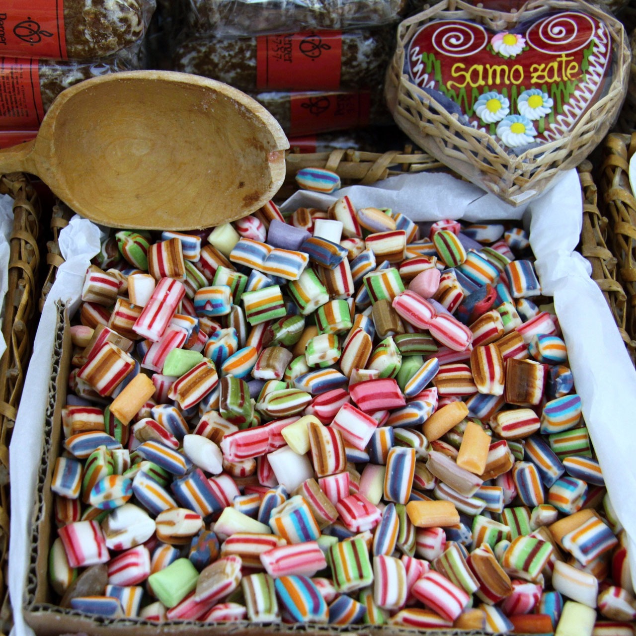Colorful toffee in wicker basket on the market free image download