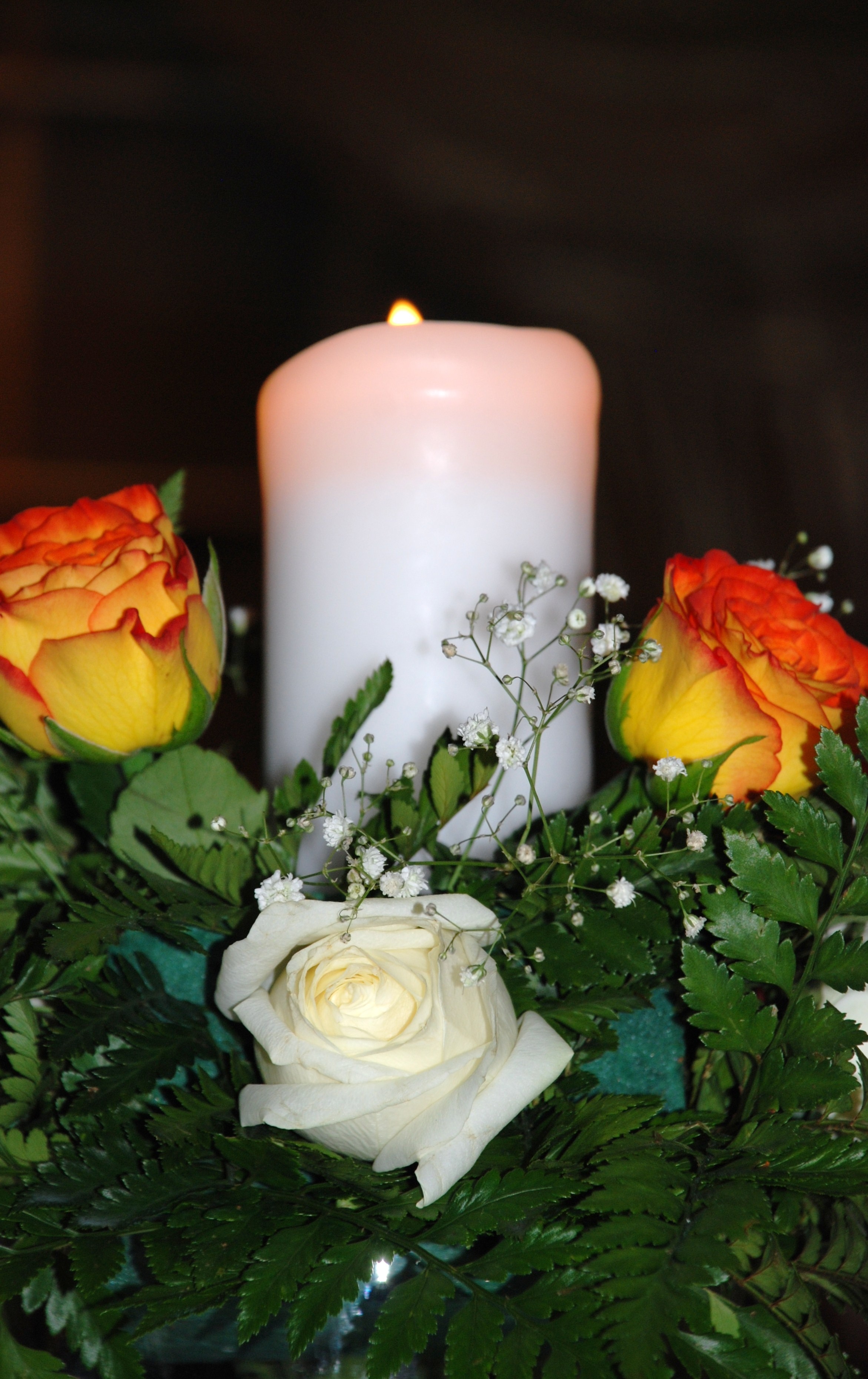 White candle near artificial flowers free image download