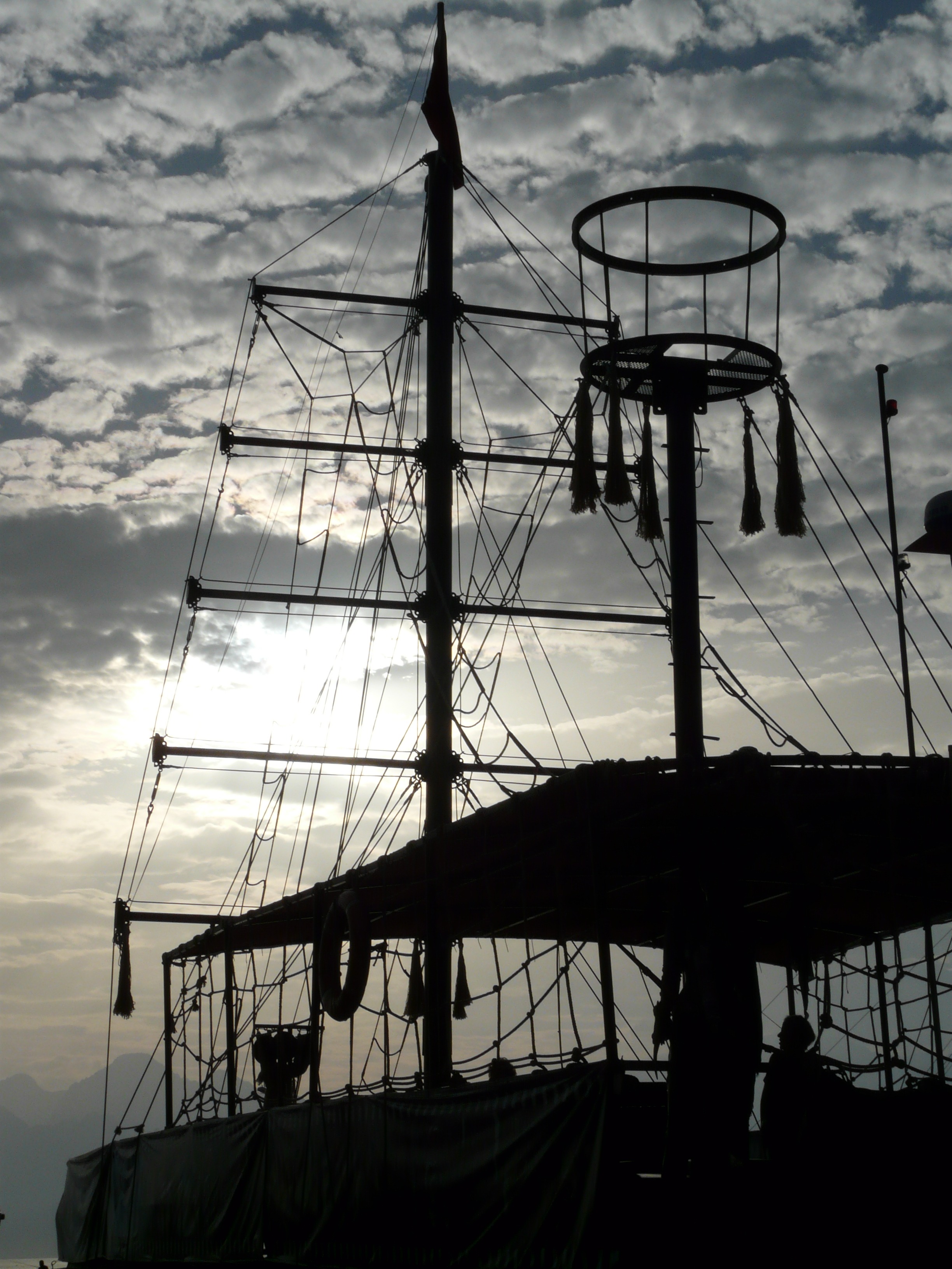 Silhouettes of a sailing ship match at dusk free image download