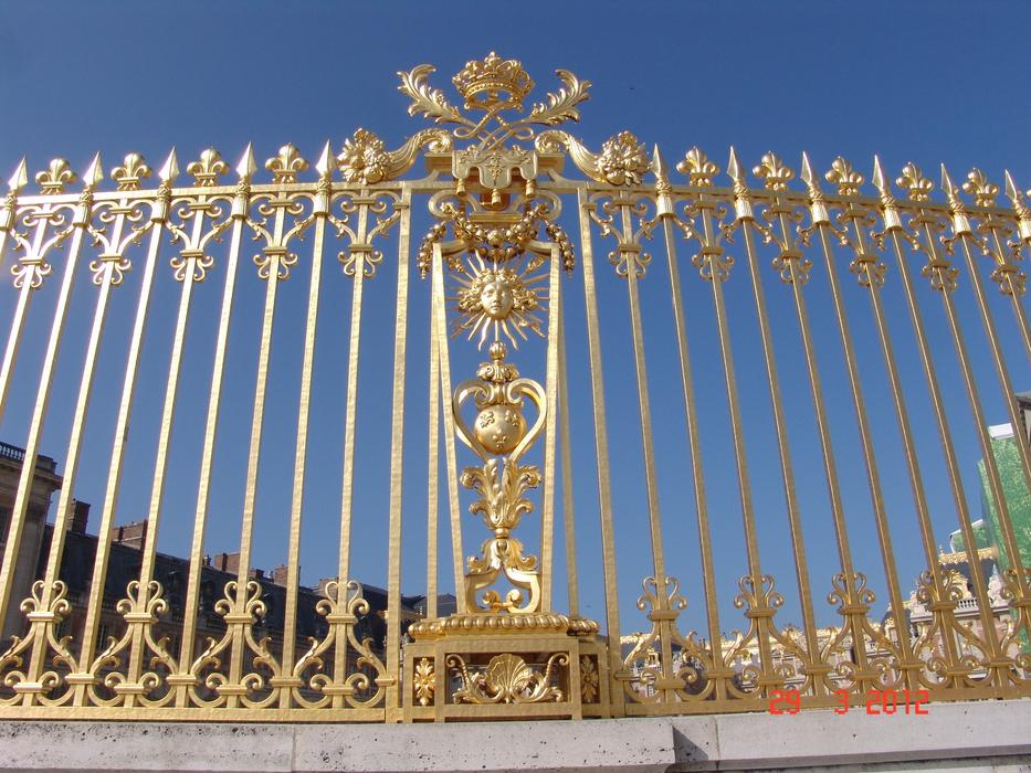 Beautiful, gold gate with the ornament and decorations, at blue sky on ...
