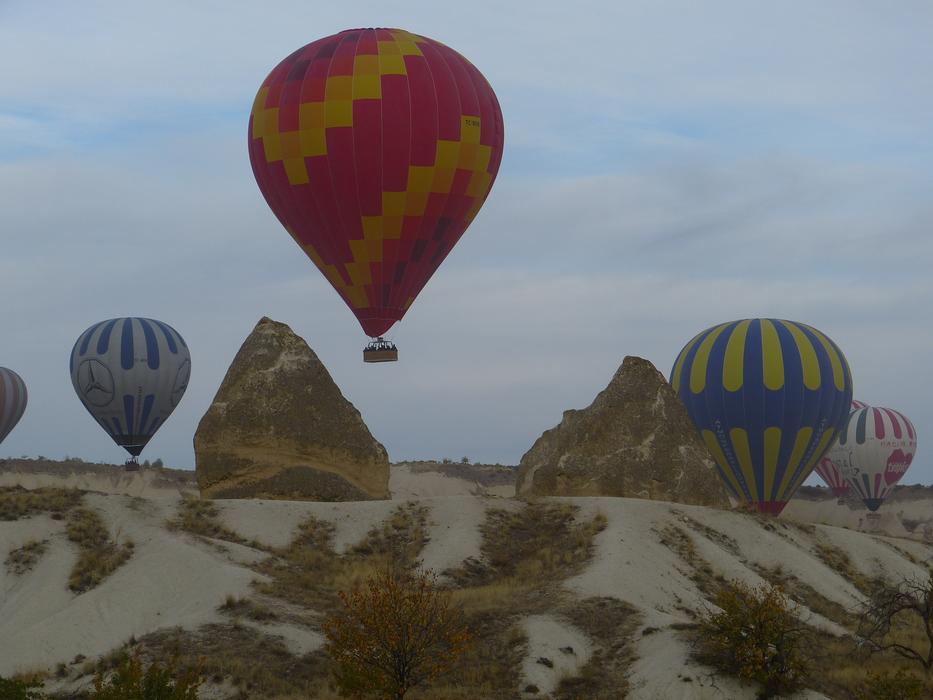 Colorful balloons flying over the hills free image download