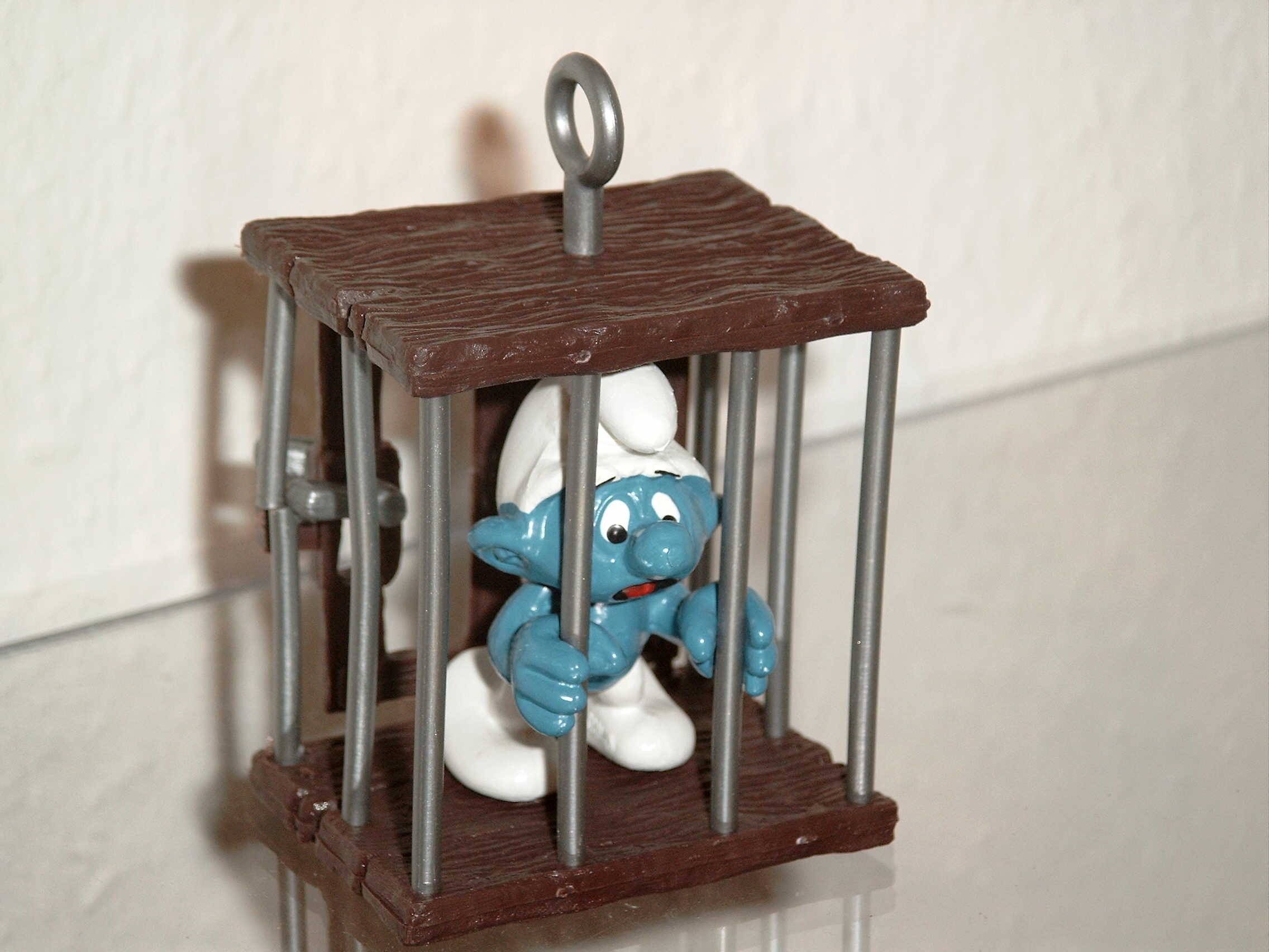 Cute, blue and white figure of the smurf, in prison free image download
