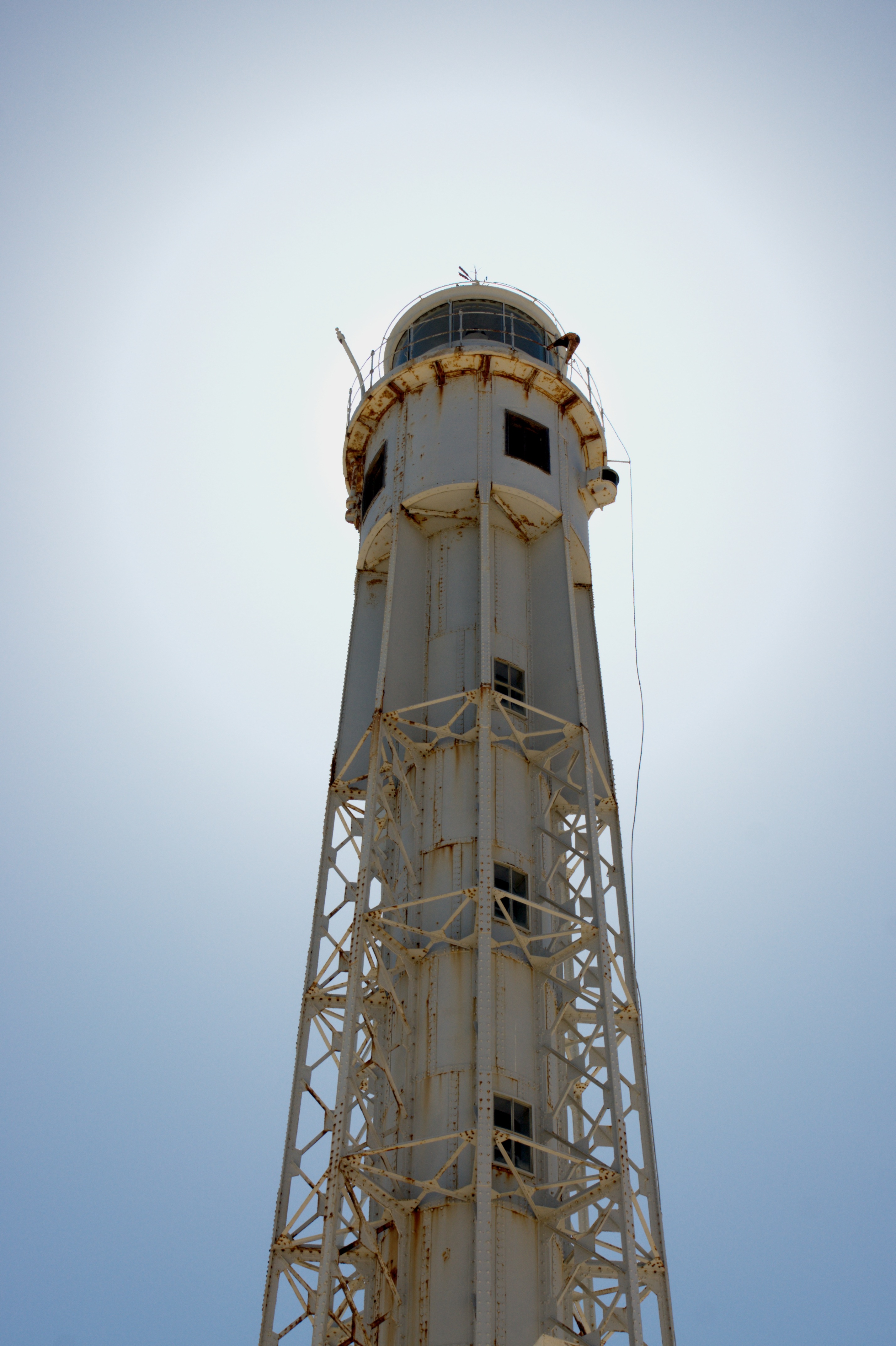 Tall lighthouse towering straight up into the sky free image download