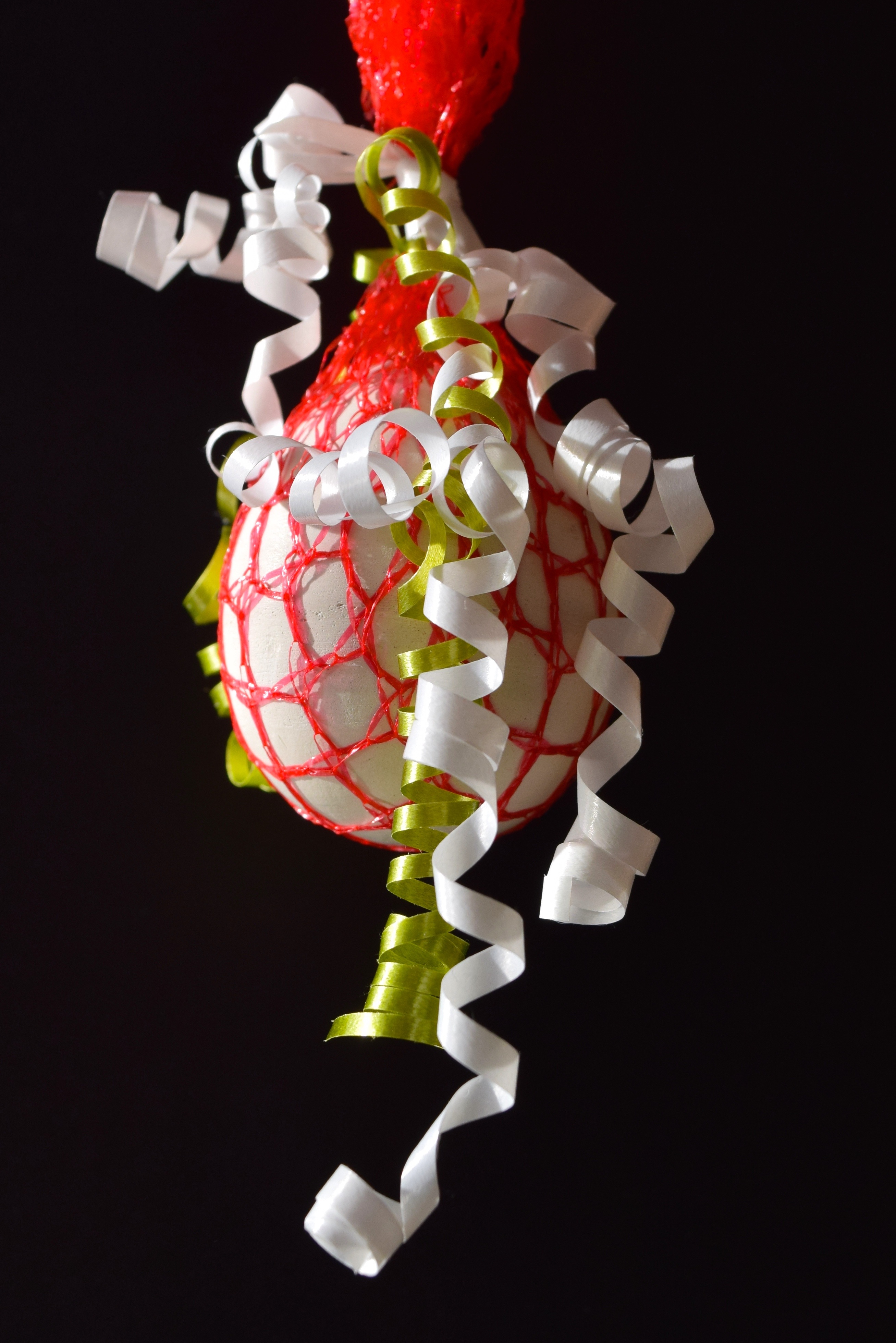 Egg decorated with red net and ribbons free image download