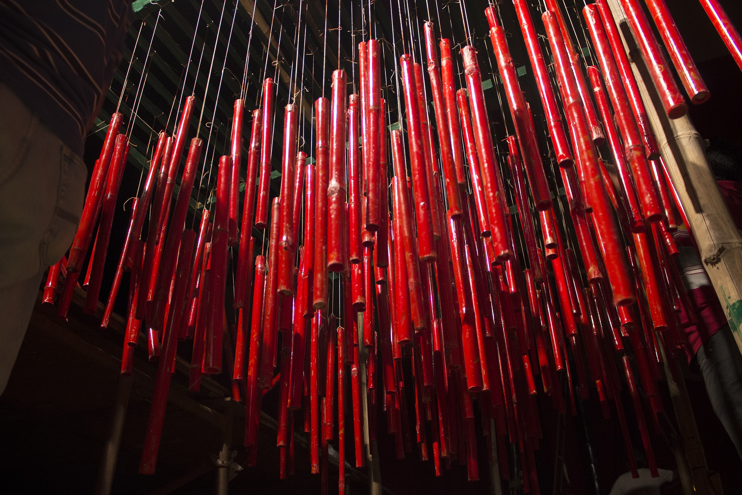 Red Bamboo tubes hanging from ceiling free image download