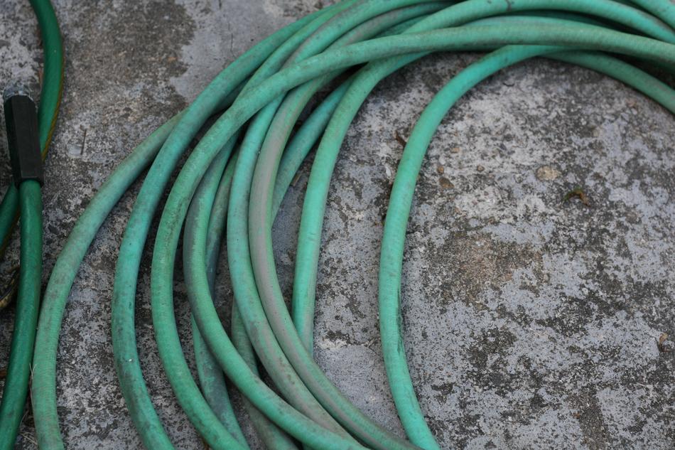 Old Green Garden Hose coiled on ground free image download