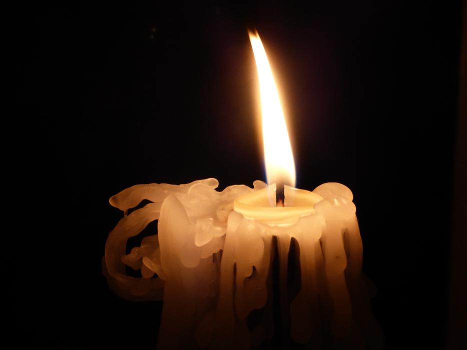 Burning wax candle in the dark free image download