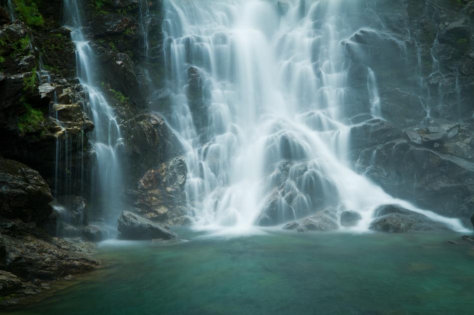 Waterfall beating against the rocks free image download
