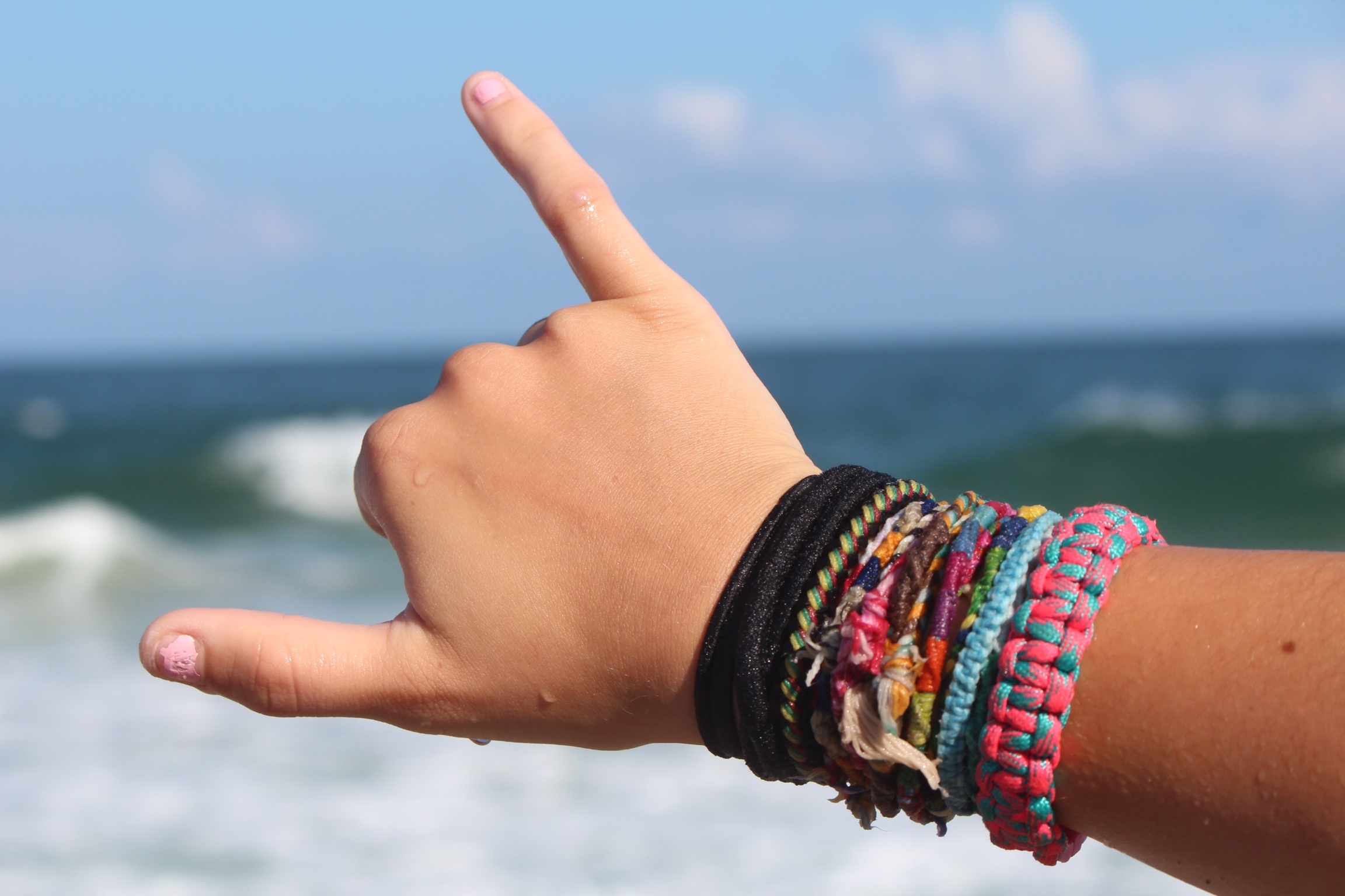 Hand sign with bracelets free image download
