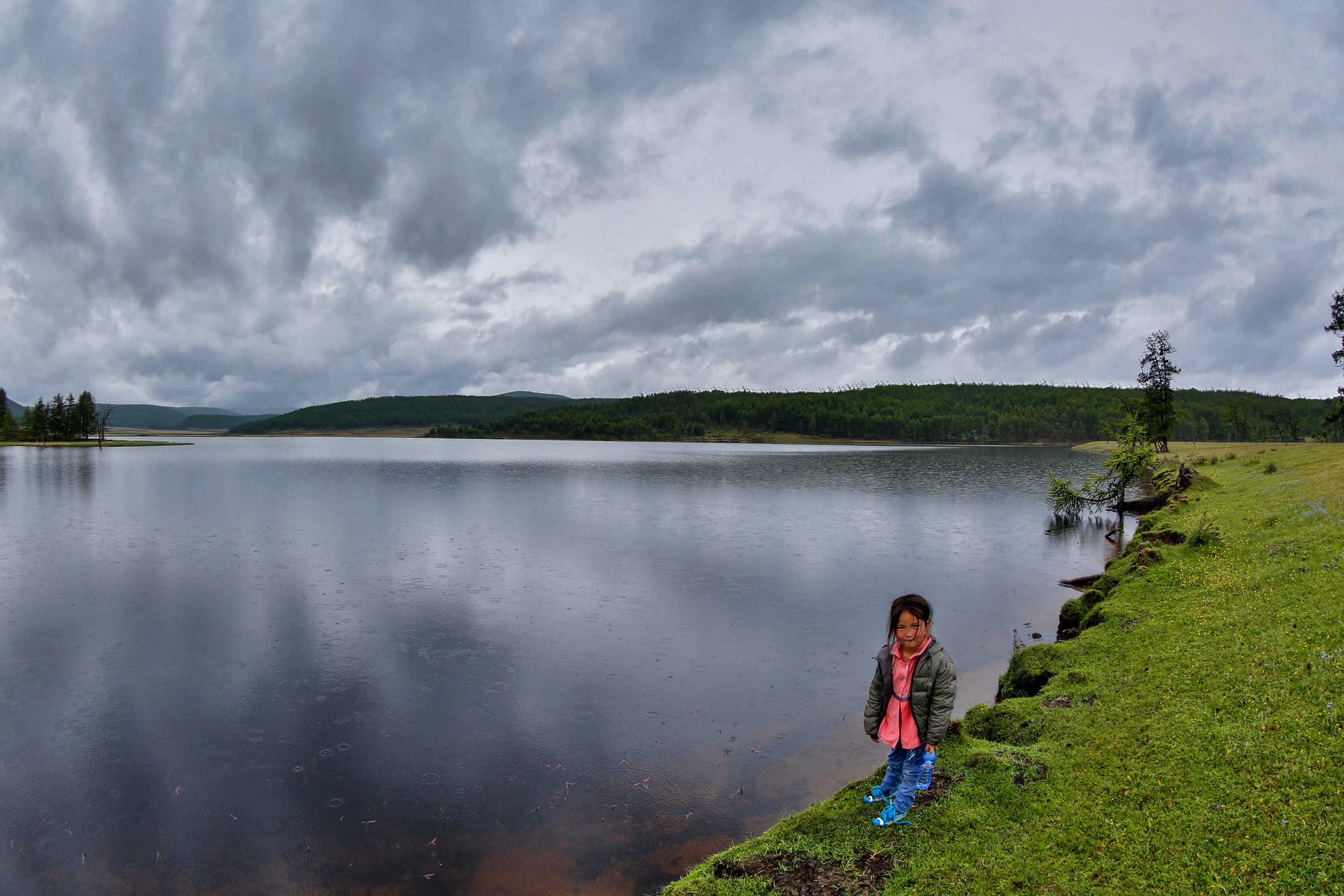 A man walking near the lake free image download