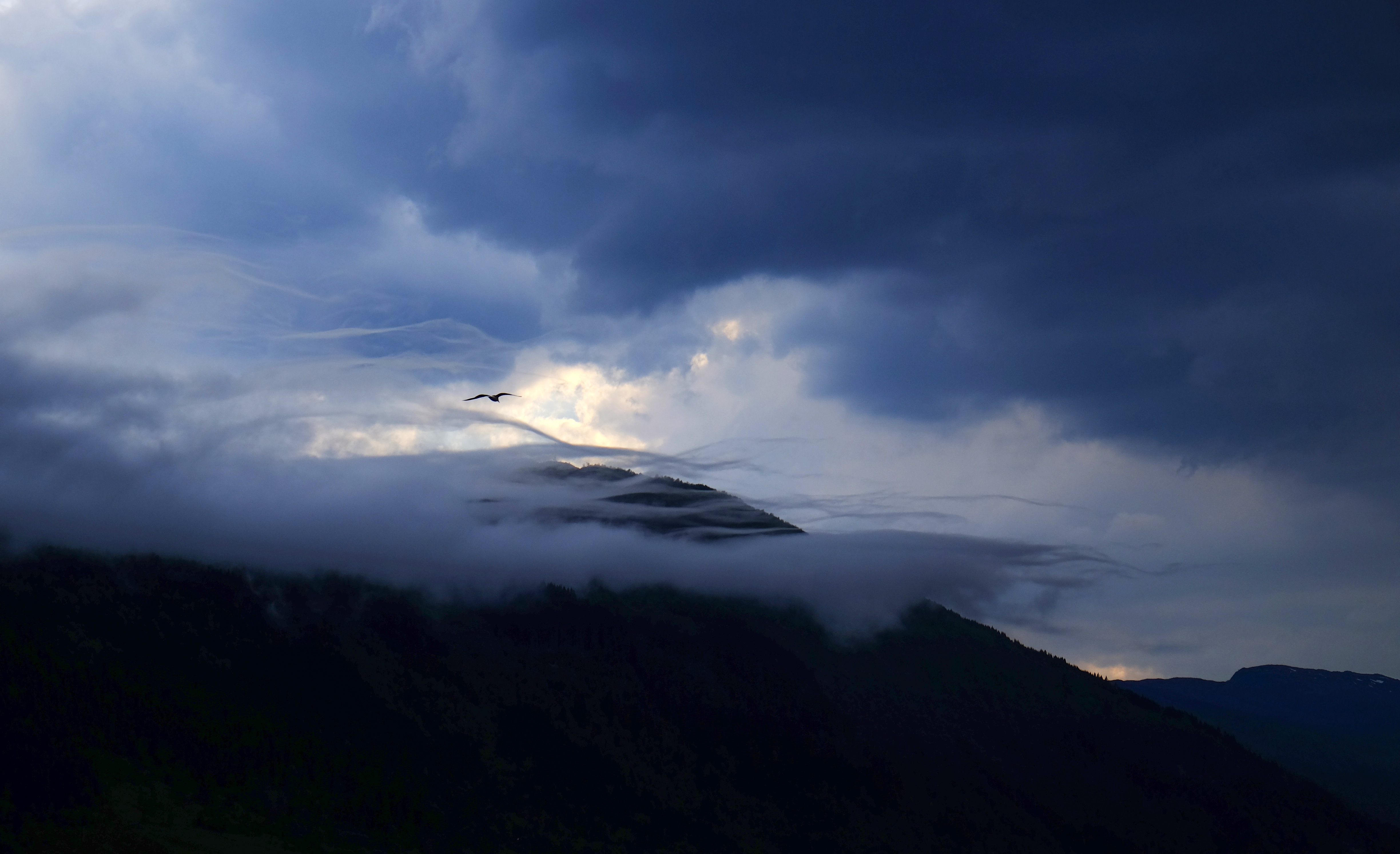 Floating clouds over mountain tops free image download