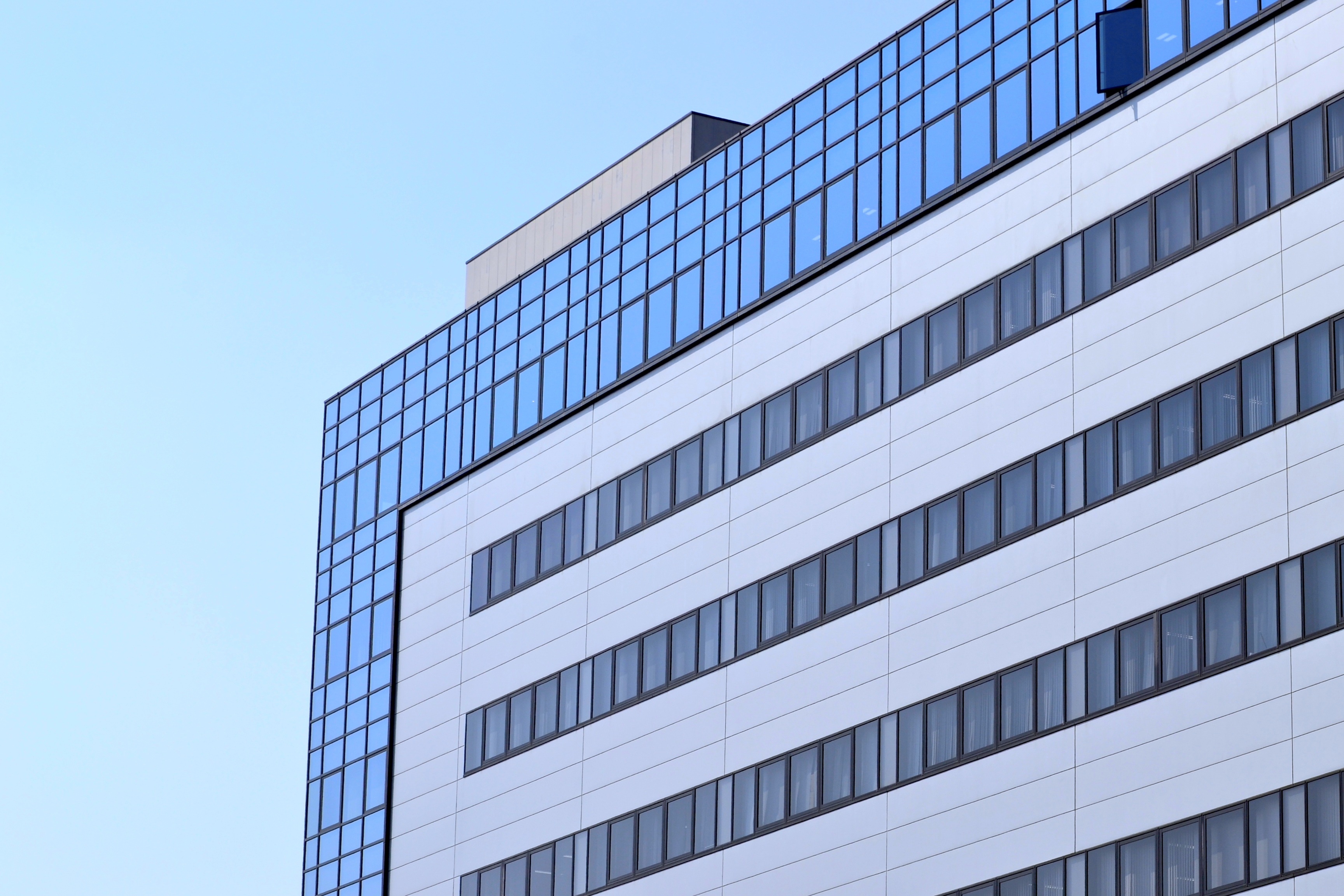 Modern glass building with white facades free image download